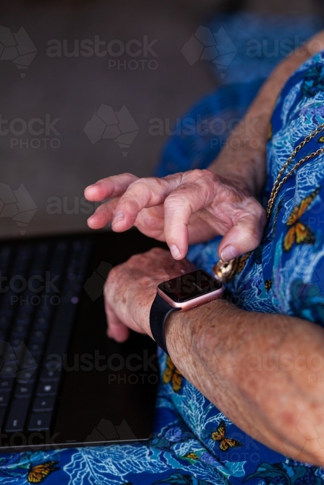 Image of senior person using smartwatch technology - Austockphoto
