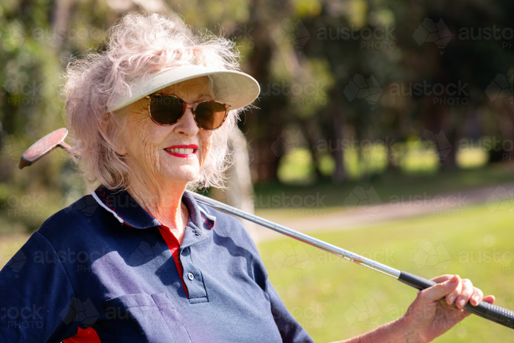 Image of senior woman at golf - Austockphoto