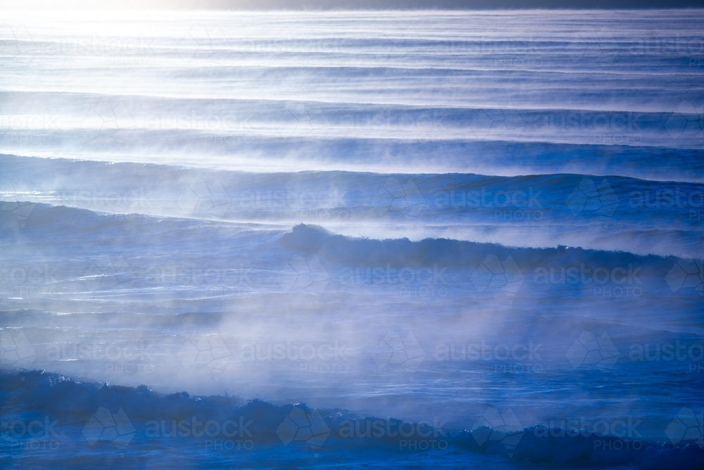 Image of Series of ocean waves with notable mist above them - Austockphoto
