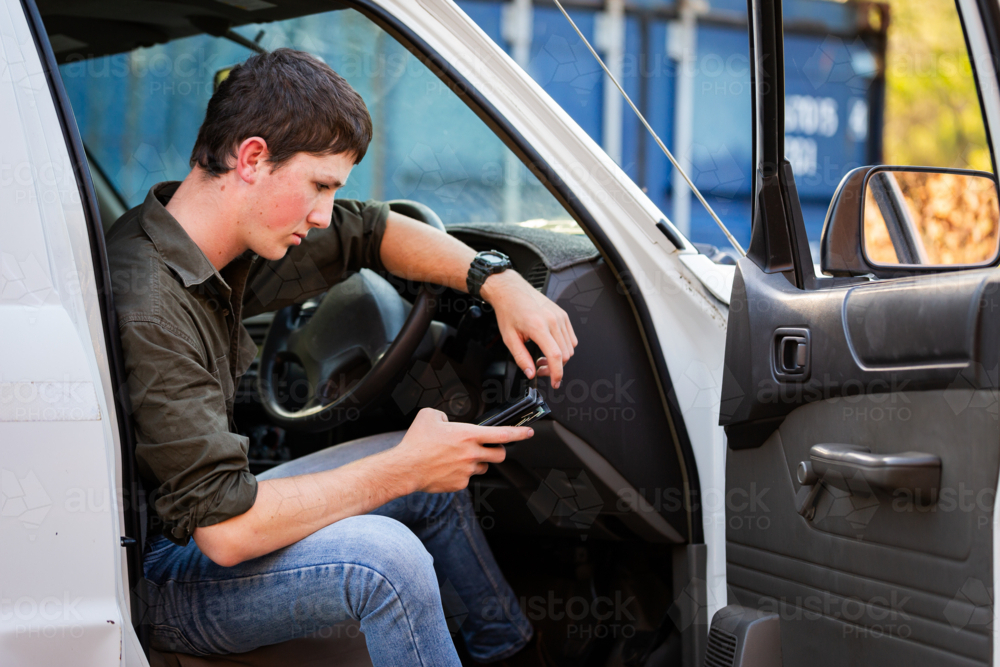Image of serious teenaged Australian young man sitting in his ute ...
