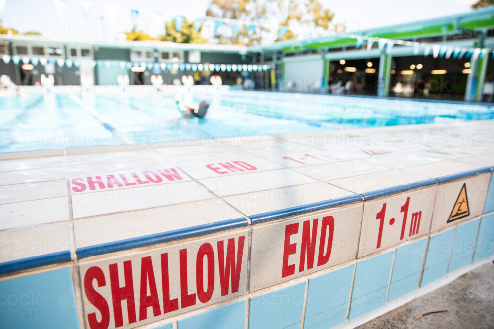 Image of shallow end tiles at a public swimming pool - Austockphoto