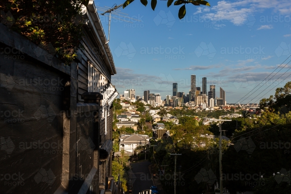 Image of side of a shady timber house with Brisbane city in the ...