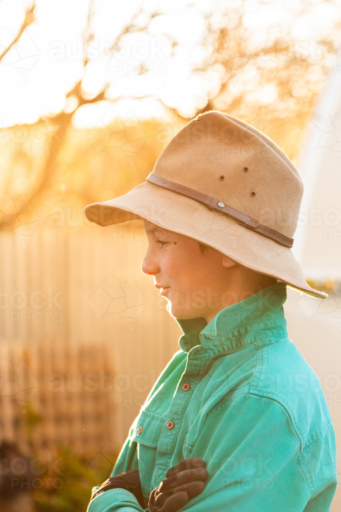Image of side profile of aussie kid in akubra hat in golden glow of ...