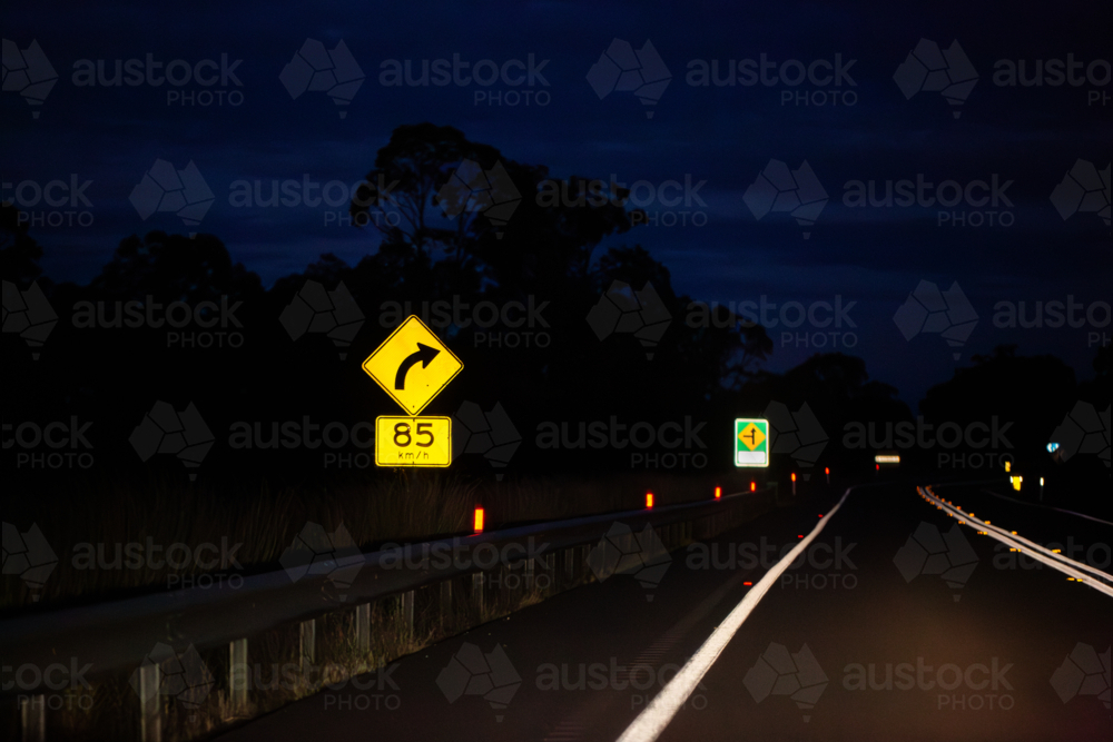 Image of Sign on Golden Highway at night with arrow with 85 km/h ...