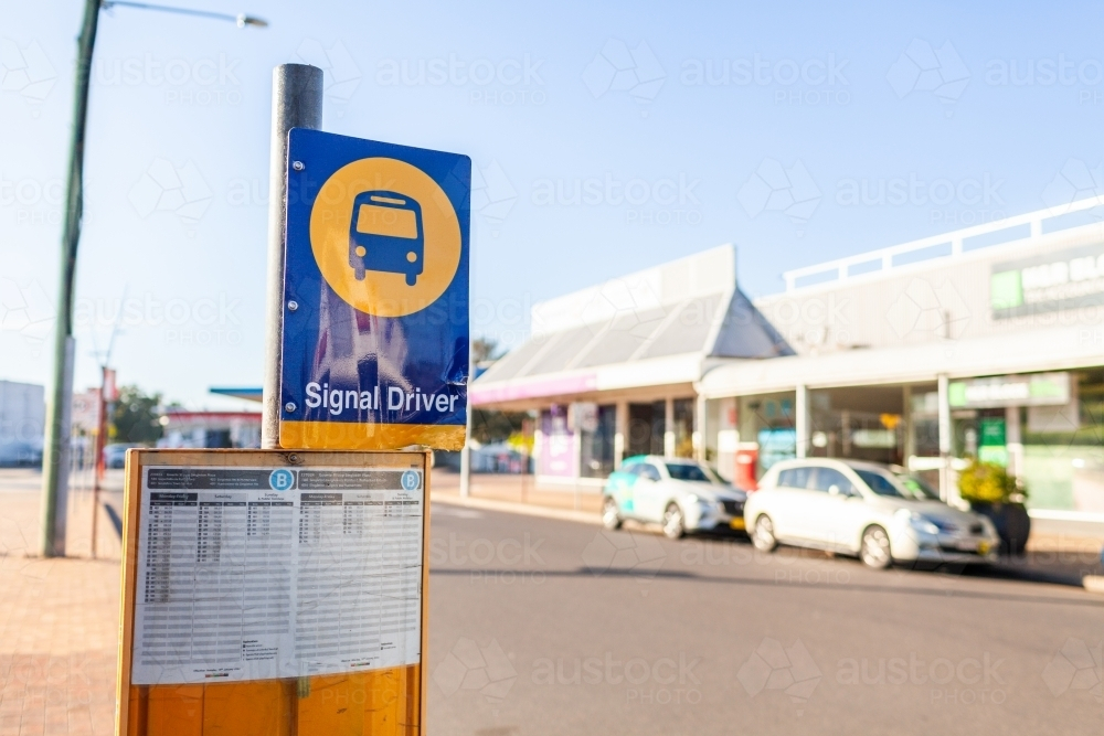 Image of Signal driver bus route sign and timetable beside road ...