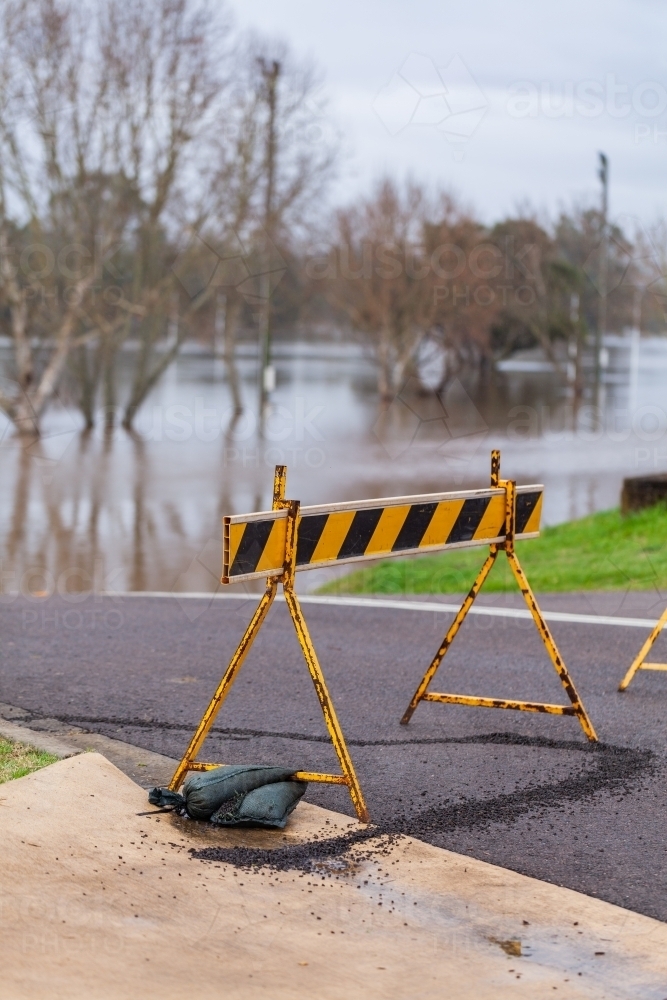 Image of Signs blocking off road that is underwater during flood ...