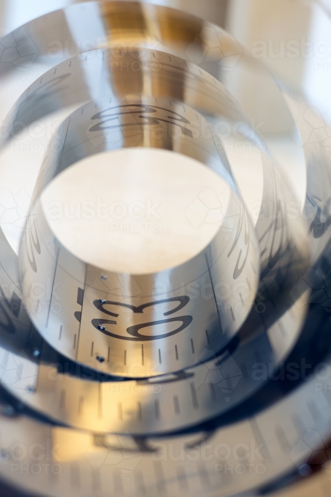 Image of Silver metal curled measure tape - Austockphoto