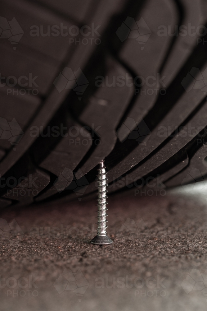 Image of Silver screw and car tyre - puncture in car wheel concept ...