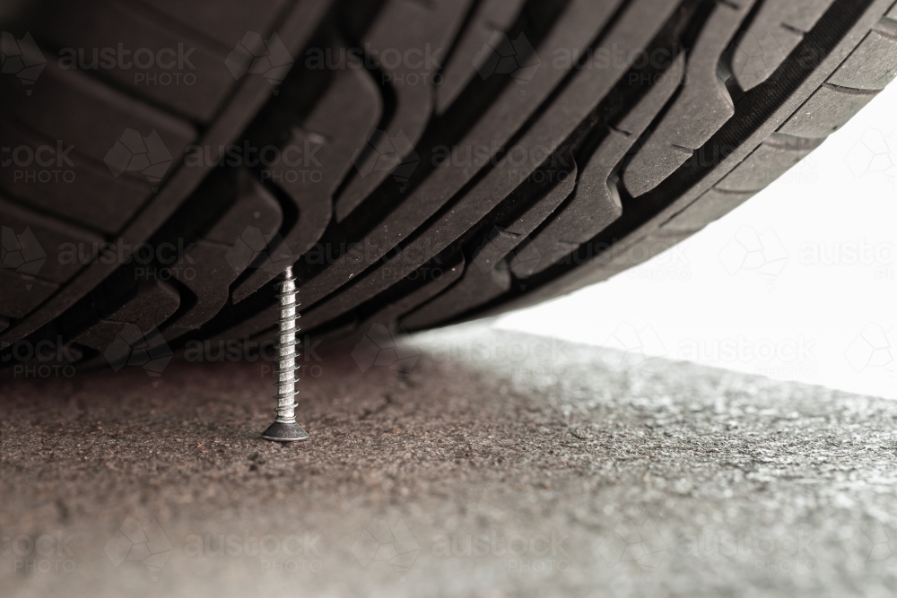 Image of Silver screw and car tyre - puncture in car wheel concept ...