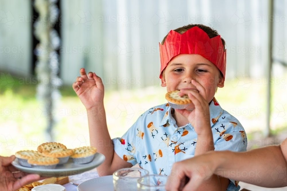 Image of six year old Aussie kid eating fruit mince pie for dessert at ...