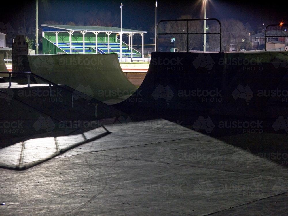 Image of Skate ramp looking through to a grandstand - Austockphoto