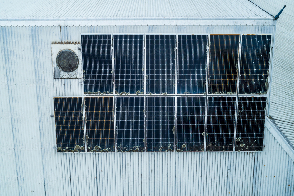 Image of Sky light and rows of dirty solar panels installed on steeply ...