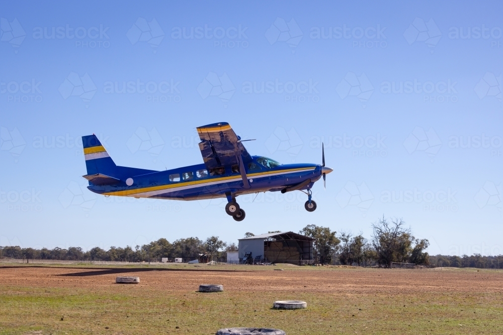 Image of small single propeller aeroplane taking off a rural airstrip ...