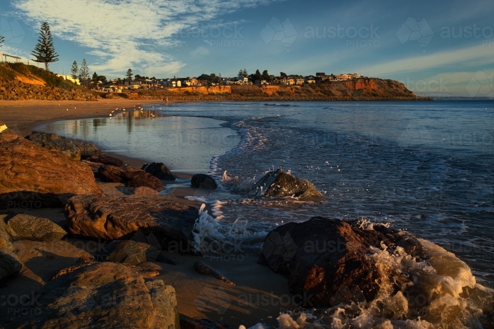 Image of Small Wave Hitting Rocks at a Beach - Austockphoto