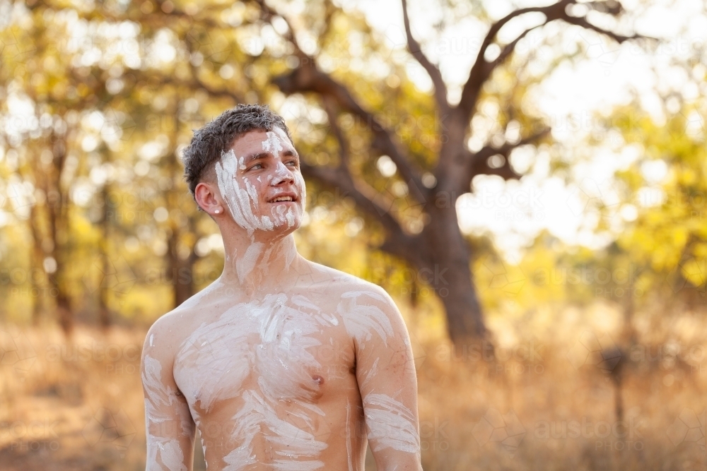 Image of Smiling aboriginal teen on country with bokeh bushland ...