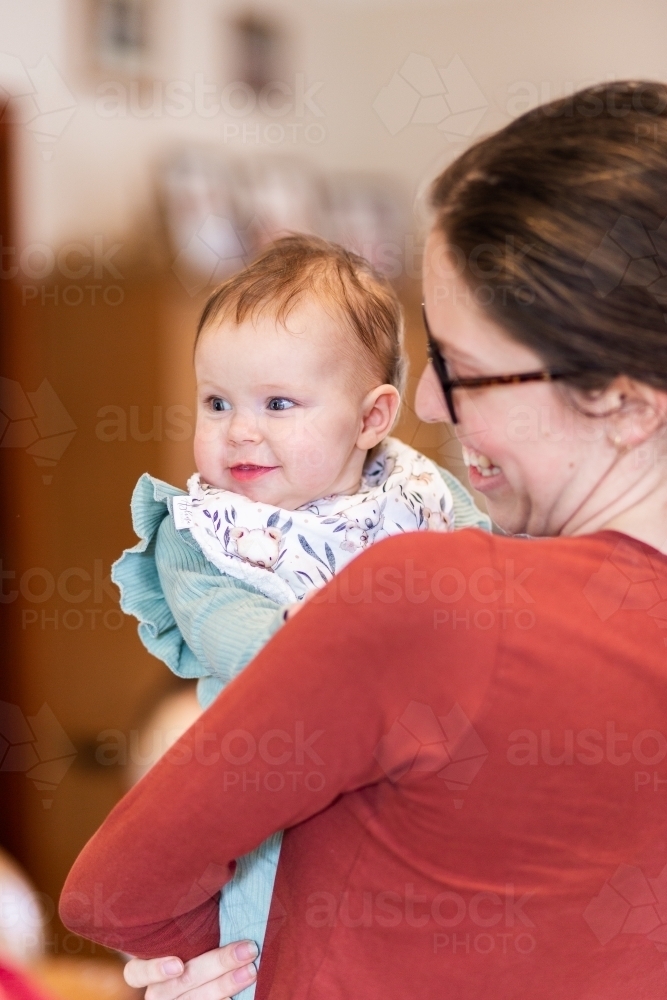 Image of Smiling baby being cuddled by happy aunty - Austockphoto