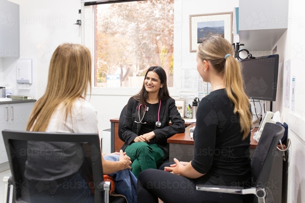 Image of smiling female doctor in a clinic with stethoscope around her ...