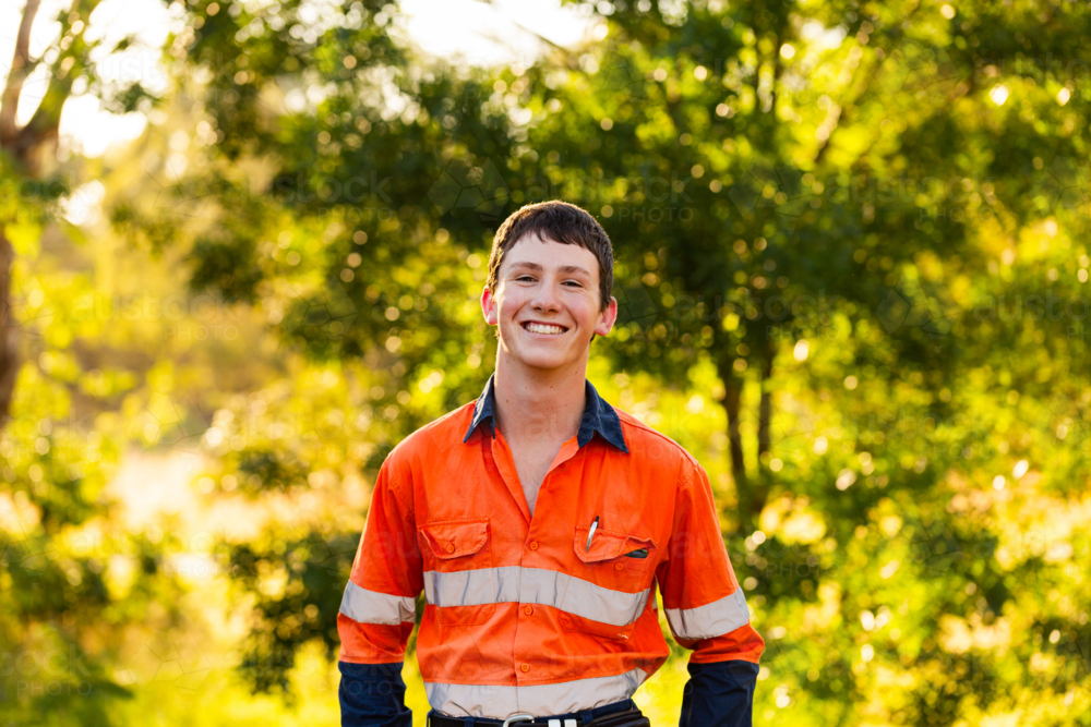 Image of smiling happy young tradesman apprentice in high vis workwear ...