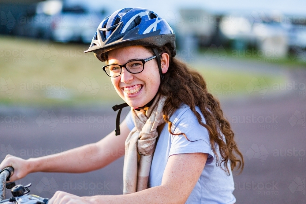 Image of Smiling portrait of a young lady in her twenties riding with a ...