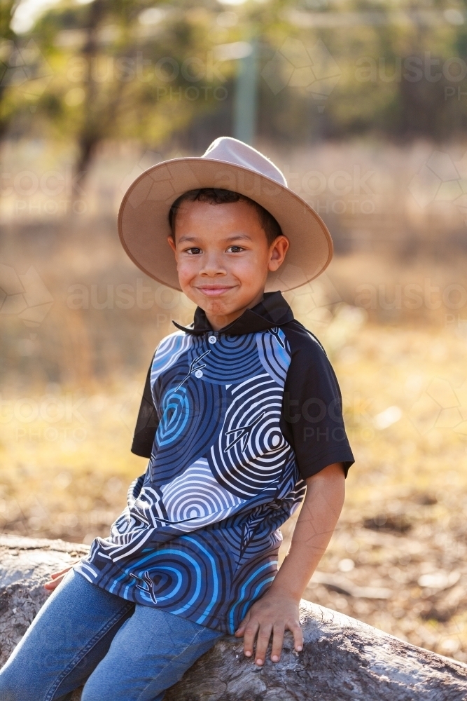 Image of Smiling portrait of young aboriginal boy wearing hat outside ...