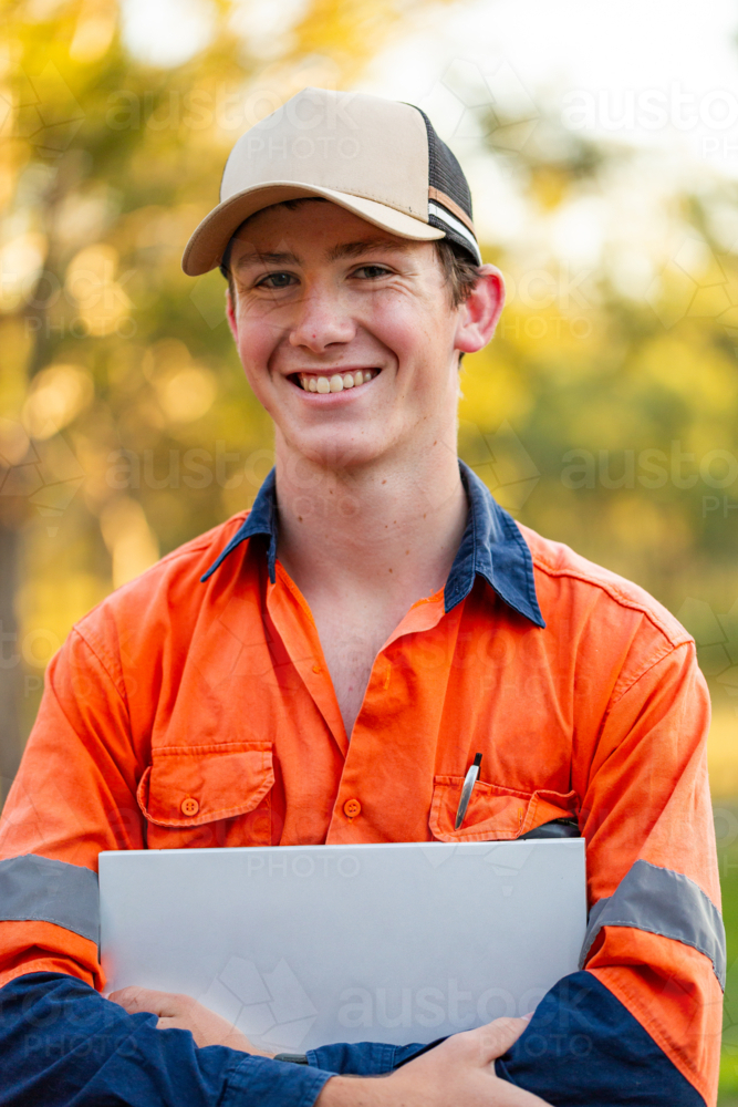 Image of Smiling portrait of young Australian man in his teens holding ...