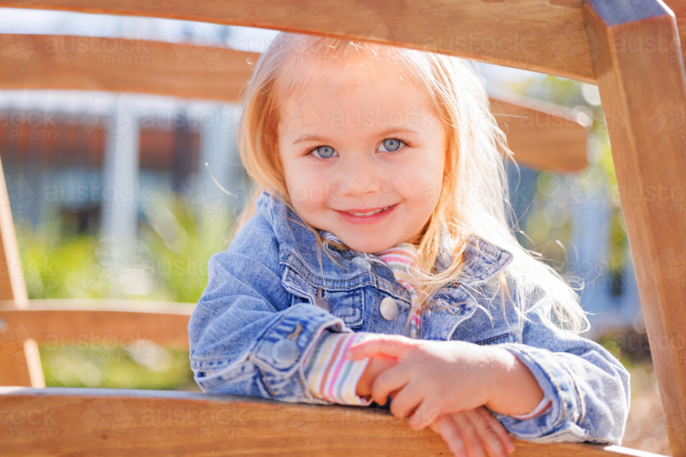 Image of Smiling preschool child on wooden bridge in kindergarten yard ...