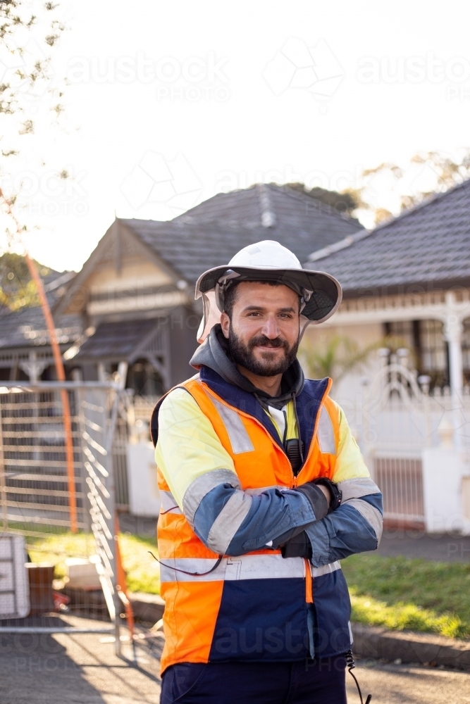 Image of Smiling road worker man with beard wearing orang and yellow ...