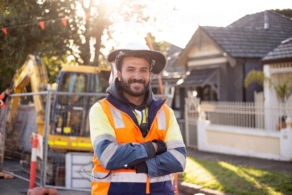 Image of Smiling road worker man with beard wearing orange and yellow ...