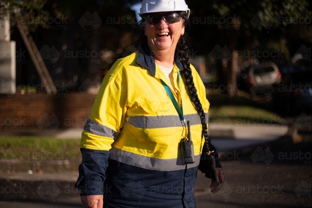 Image of Smiling traffic controller woman wearing white helmet and ...