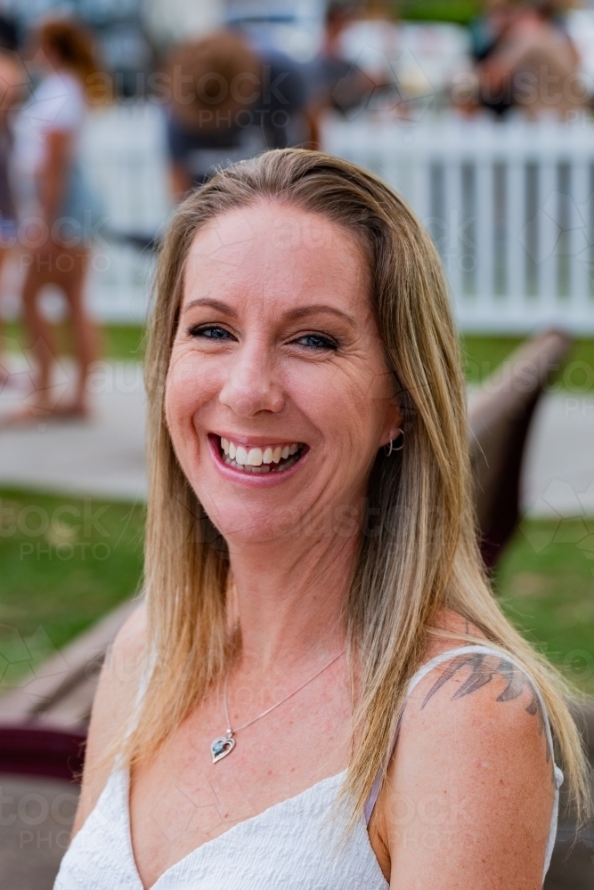Image of Smiling woman in her forties at event - Austockphoto