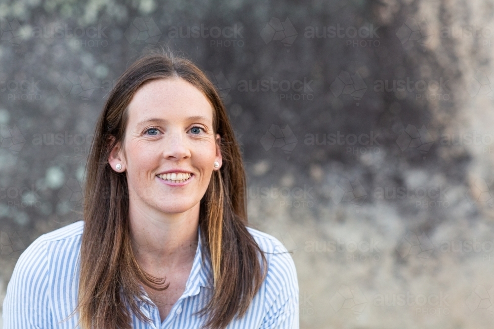 Image of Smiling young lady with blurred background - Austockphoto