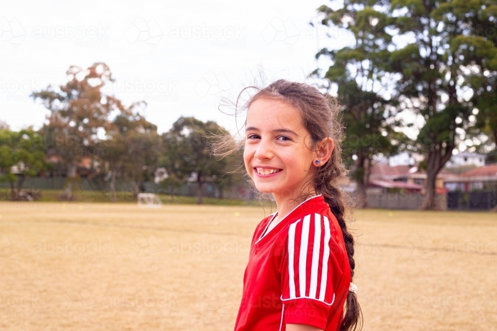 Image of Soccer player female turning to smile with copy space ...