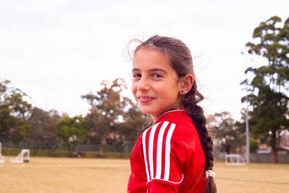 Image of Soccer player female turning to smile with copy space ...