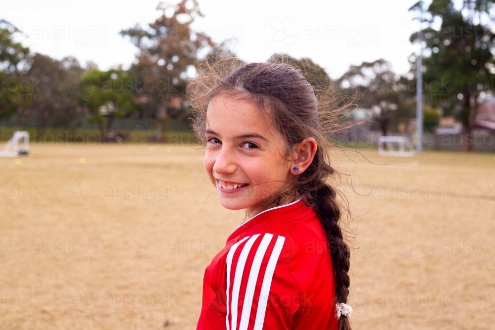 Image of Soccer player female turning to smile with copy space ...