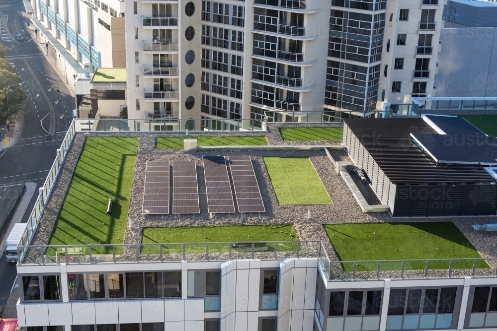 Image of solar panels on a city building rooftop - Austockphoto