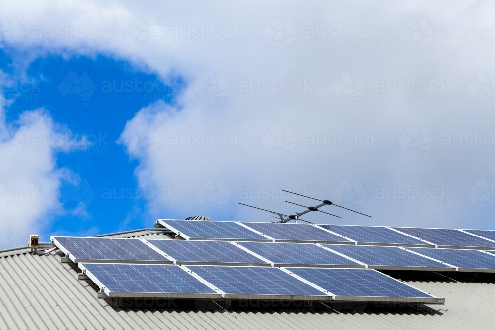 Image of Solar panels on house roof with aerial and clouds incoming ...