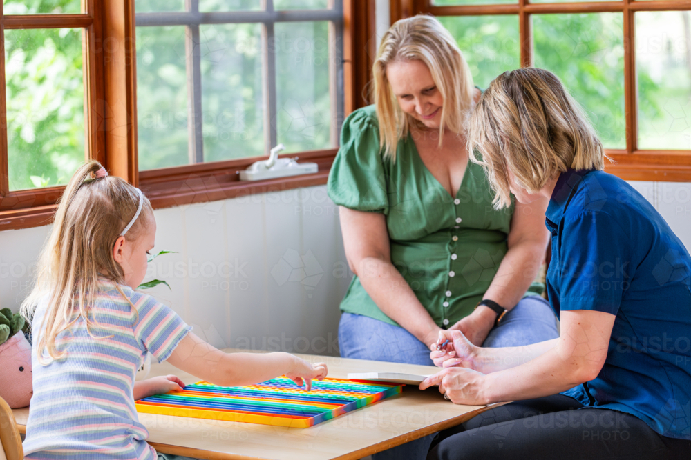 Image of speech pathologist consulting with parent while filling out ...