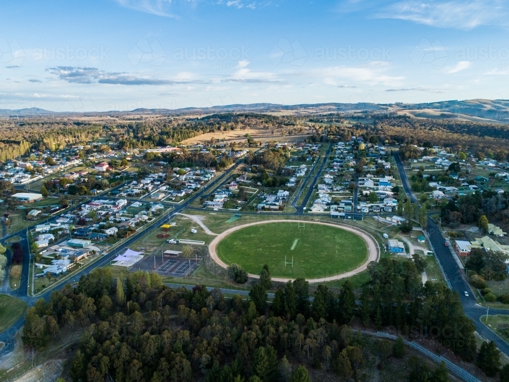 Image of Sports area with cricket pitch and tennis courts in small town ...
