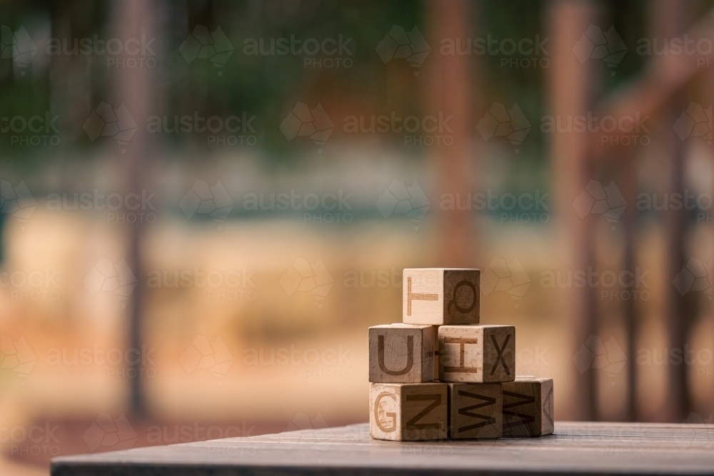 Image of Stack of wooden building blocks with letters on blurred ...