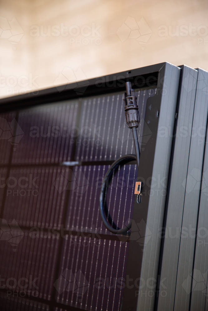 Image of stacked up solar panels ready to go on a roof - Austockphoto