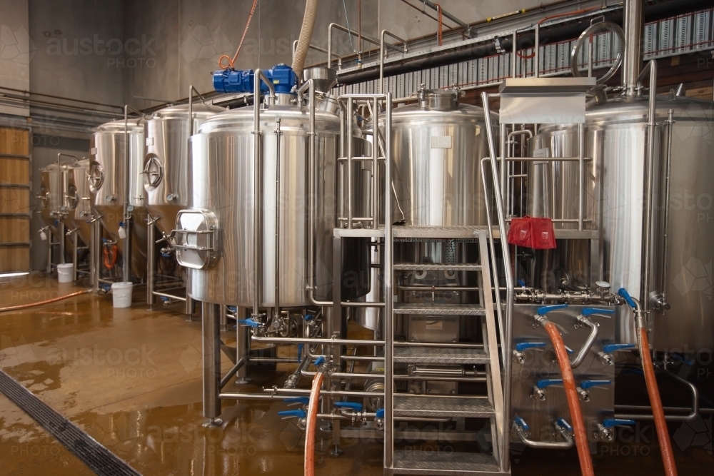 Image of Stainless steel tanks at a microbrewery - Austockphoto