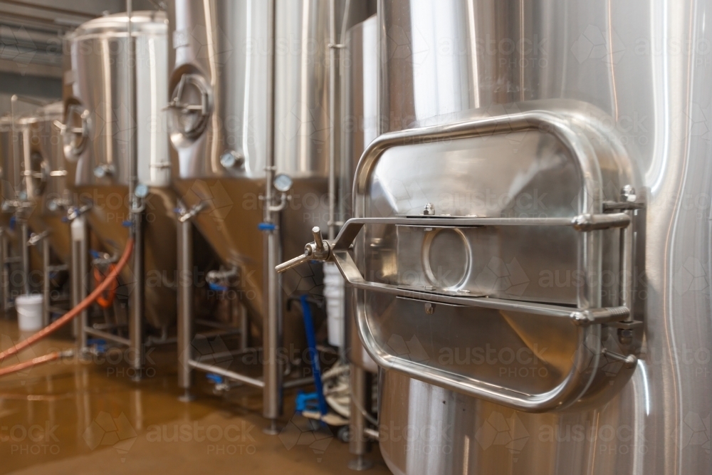 Image of Stainless steel tanks at a microbrewery - Austockphoto