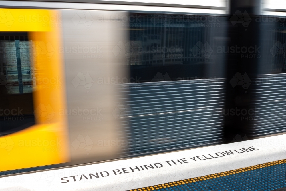 Image of Stand behind the yellow line - Austockphoto