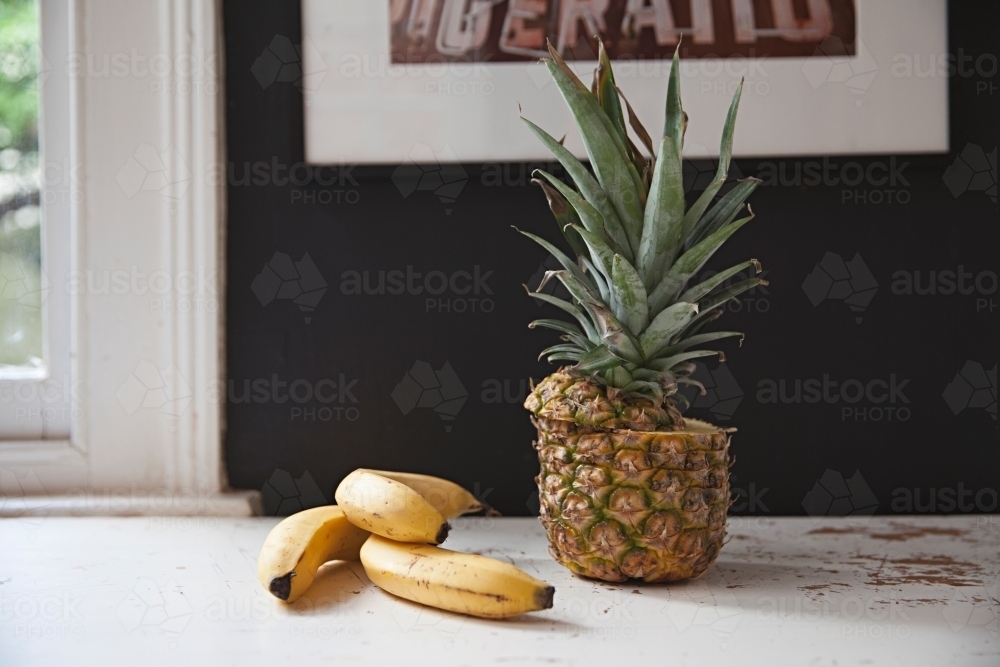 Image of Still life table top in kitchen with bananas and pineapple ...