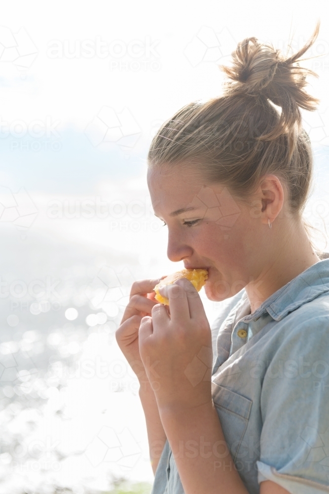 Teen Girl Eating A Mango Pip