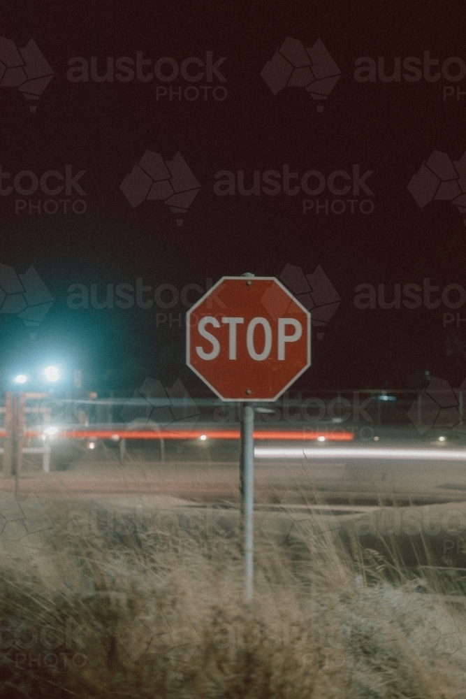 Image of Stop sign at night - Austockphoto