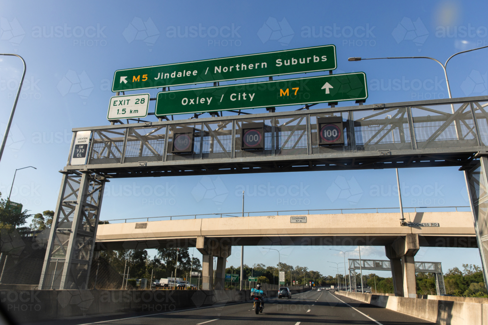 Image of street signs over a major motorway in Brisbane - Austockphoto
