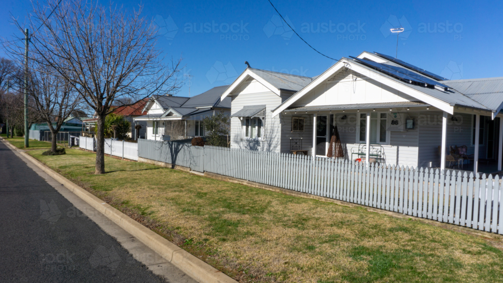 Image of Street with houses in a country town on a sunny day - Austockphoto