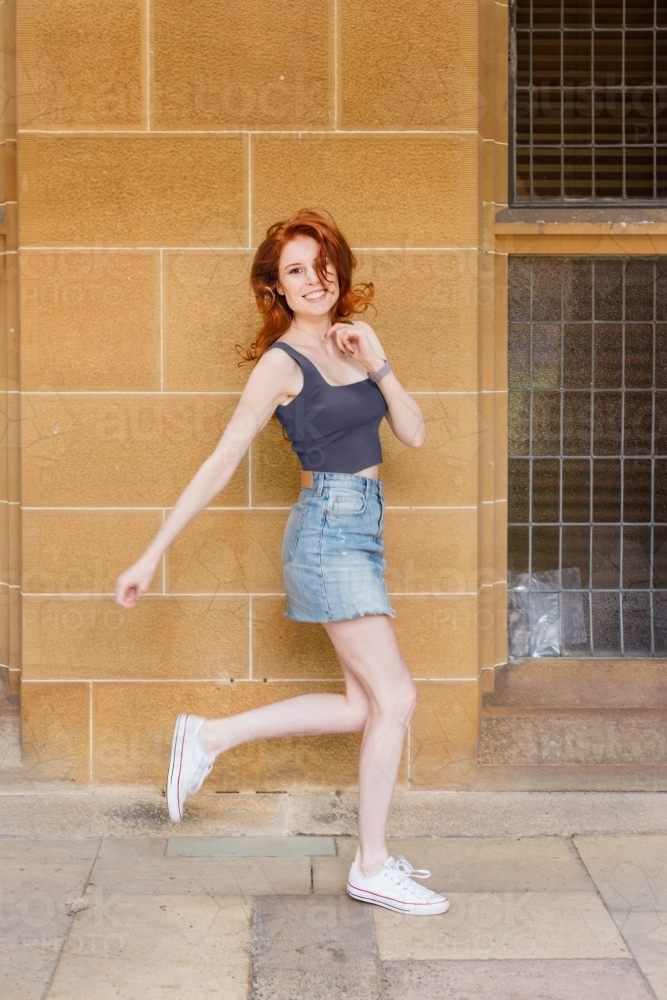 Image of student being silly on uni campus - Austockphoto