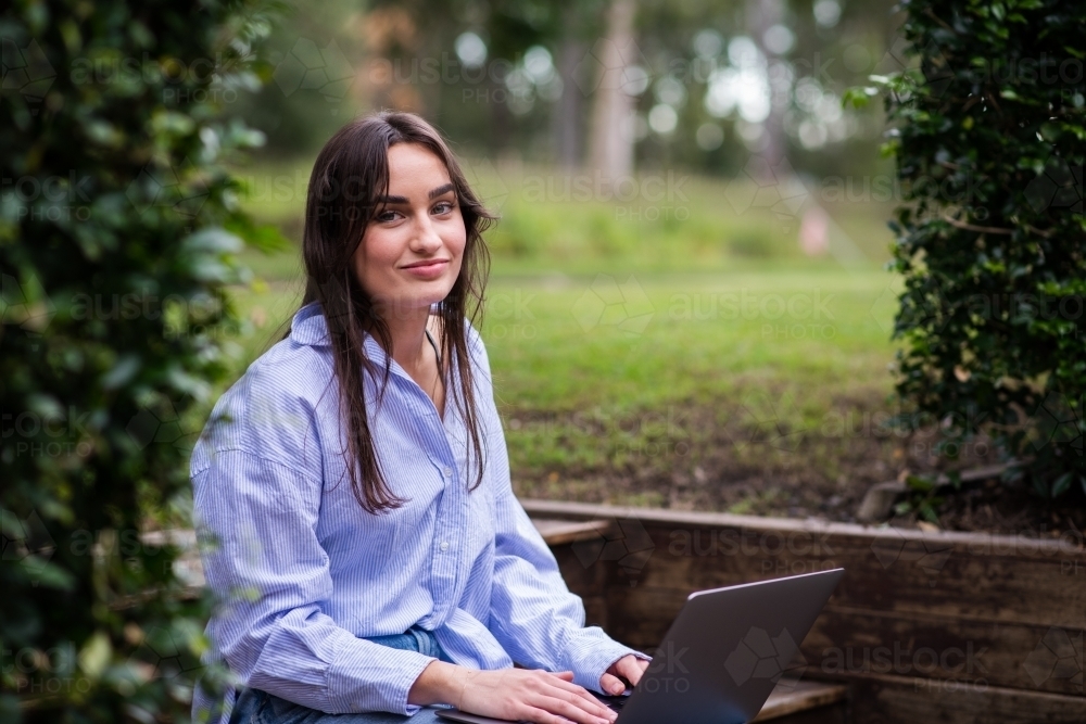 Image of student using computer on campus - Austockphoto